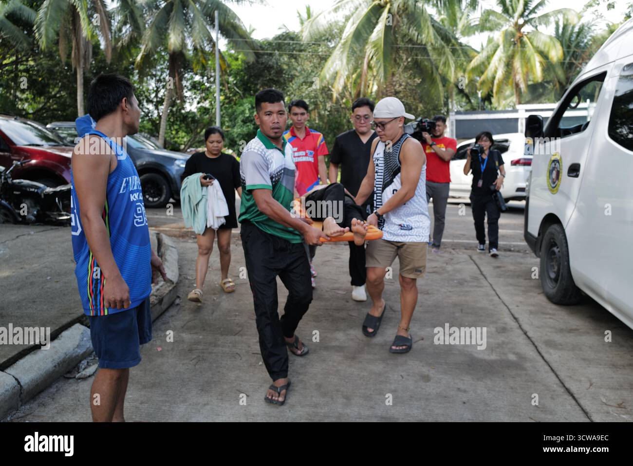 Residents carry a woman on a stretcher after an earthquake-hit Manay ...