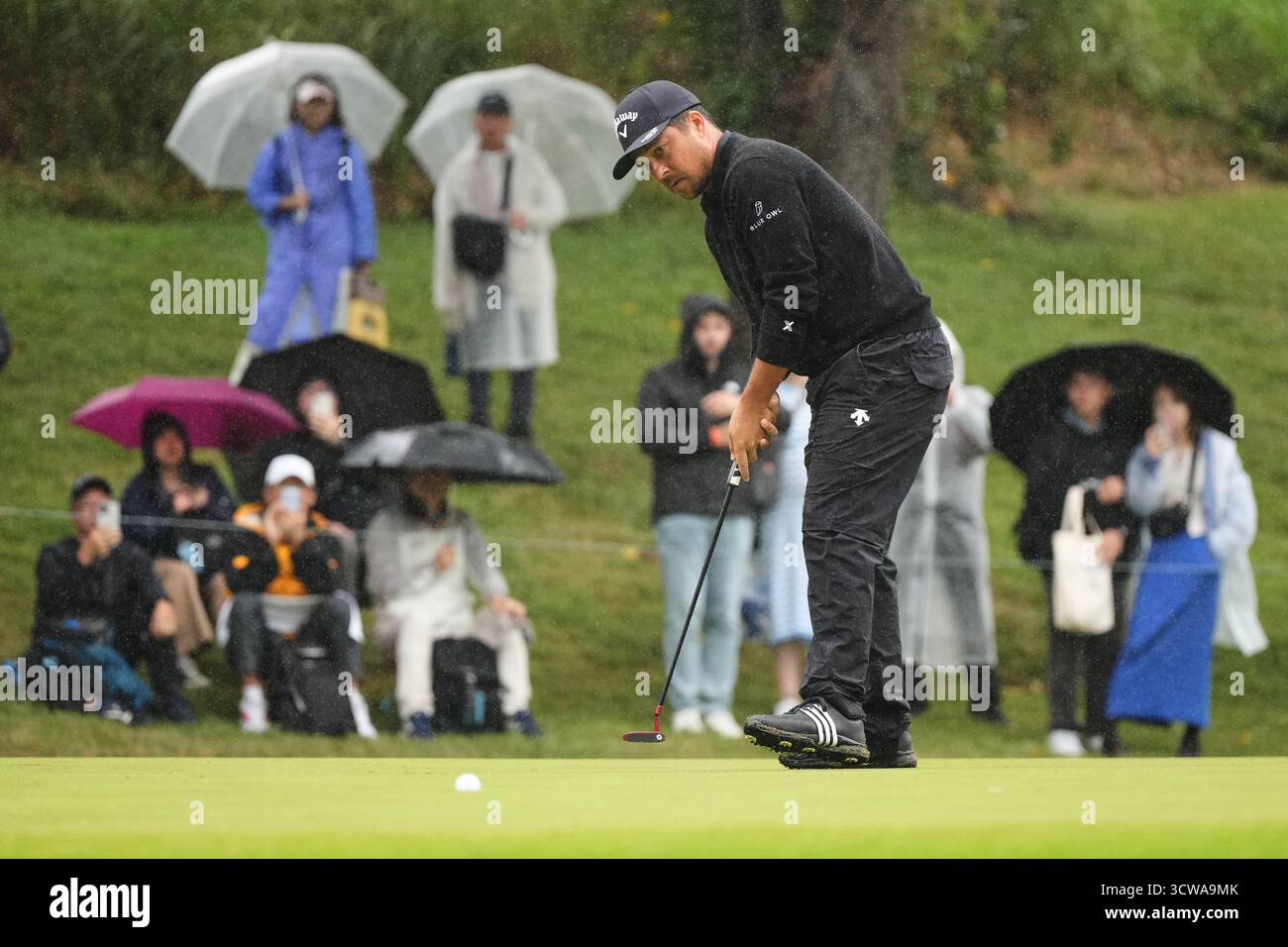 Xander Schauﬀele, of the U.S., makes a putter shot on the second green ...