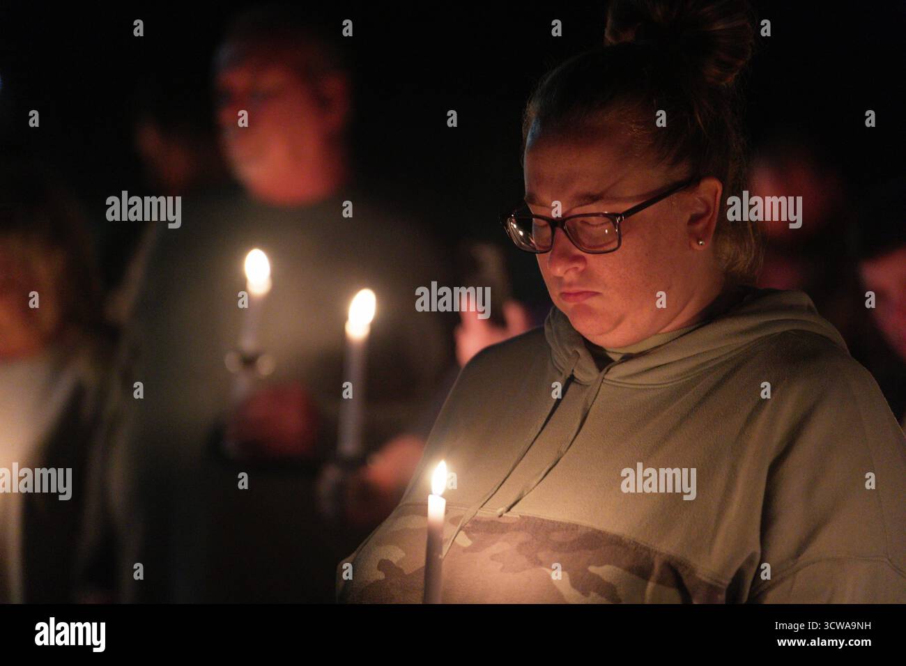 Residents attend a vigil honoring the victims of a blast at an explosives plant, Accurate ...