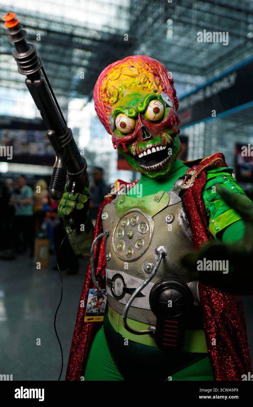 An attendee dressed as a Martian from "Mars Attacks!" poses during New York Comic Con at the ...