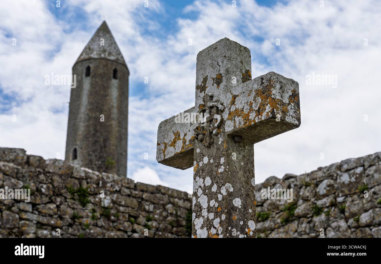 Stone cross with IHS Christogram before the leaning Kilmacduagh Round ...
