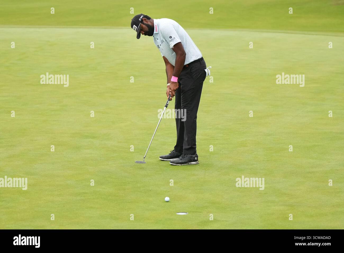 Sahith Theegala, of the U.S., makes a putter shot on the first hole ...