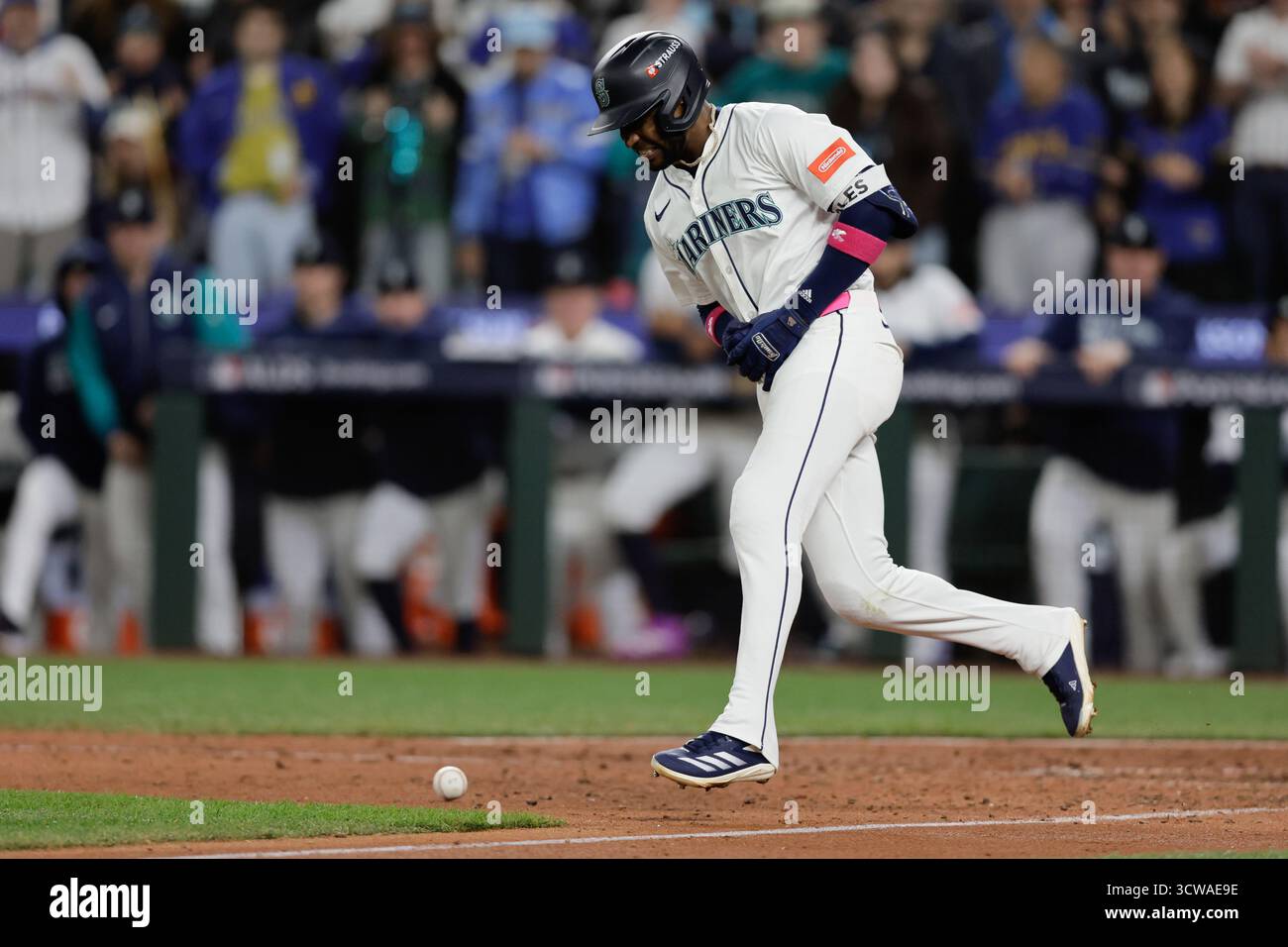 Seattle Mariners right fielder Victor Robles reacts after being hit by ...