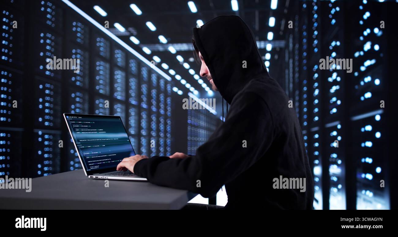The Suspicious Man Breaking Into A Server Computer Stock Photo - Alamy