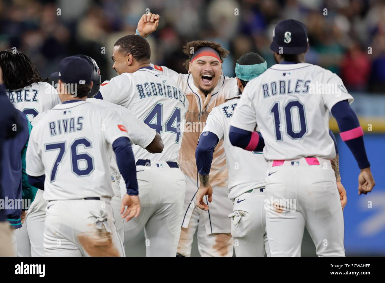 Seattle Mariners players celebrate on the field after defeating the ...