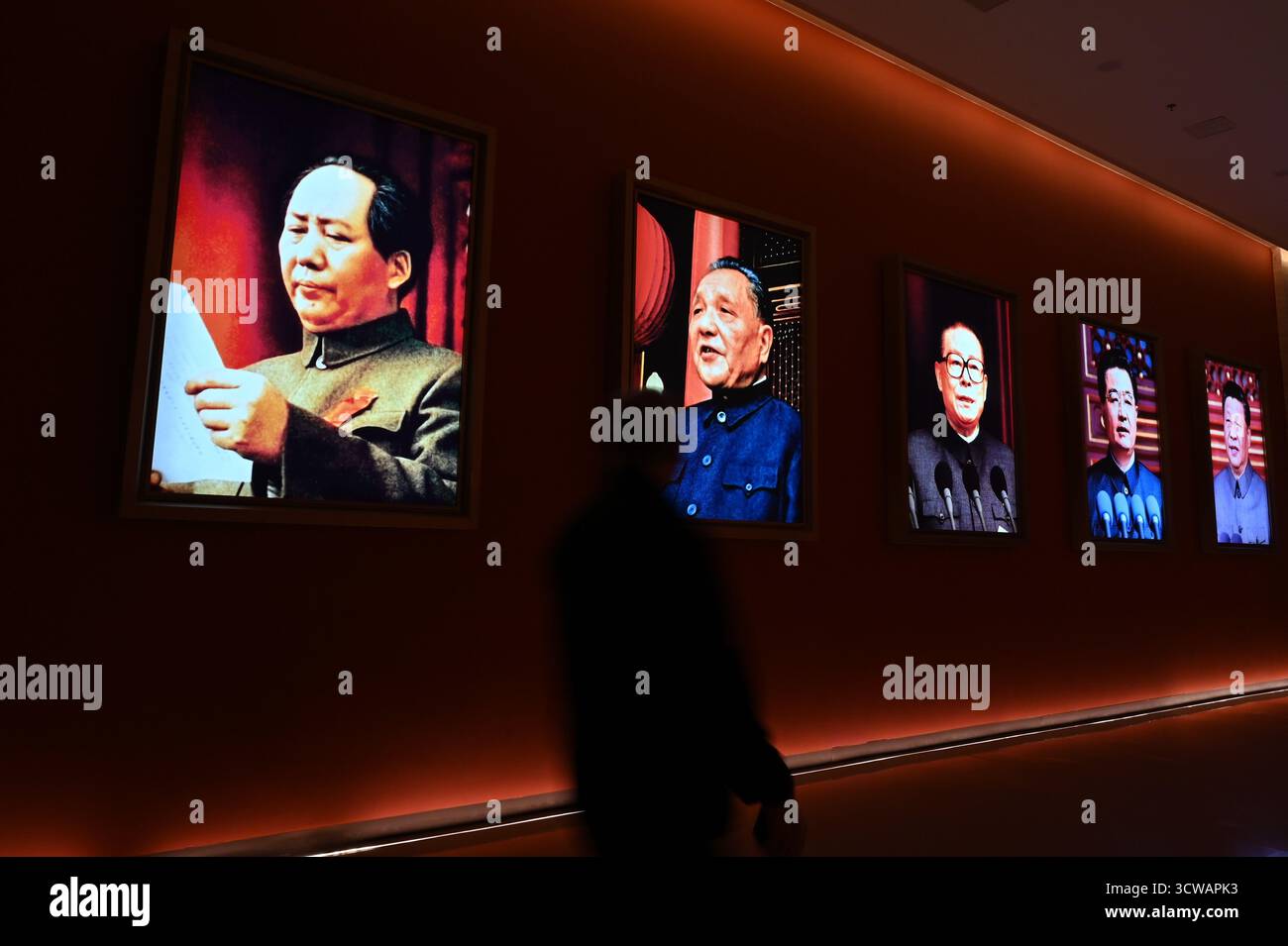 08 October 2025, China, Yan'an: A visitor walks past a wall in the ...