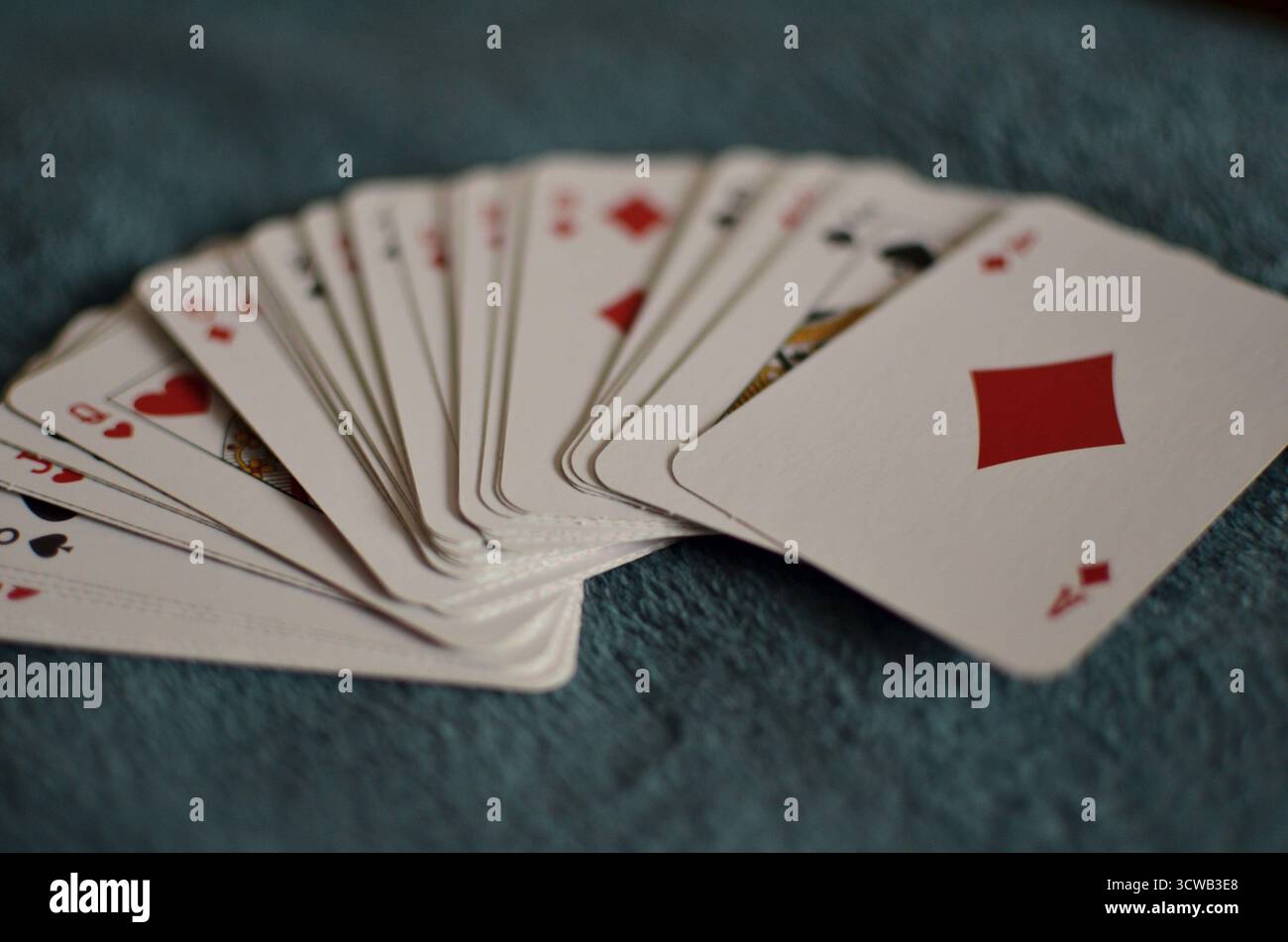 A deck of playing cards is scattered on the floor, background Stock ...