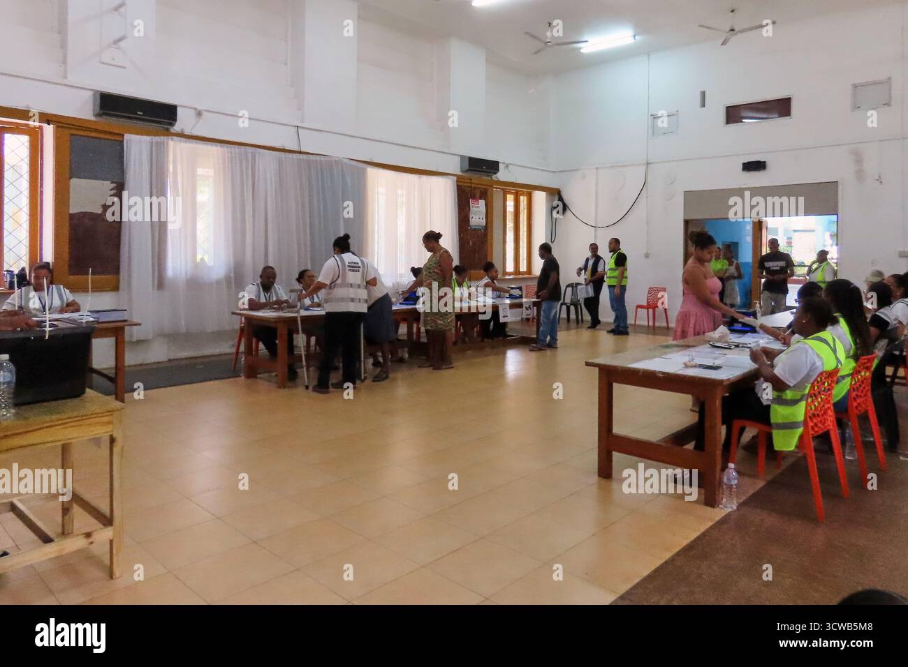 Electoral commission staff monitor as people cast their votes in a ...