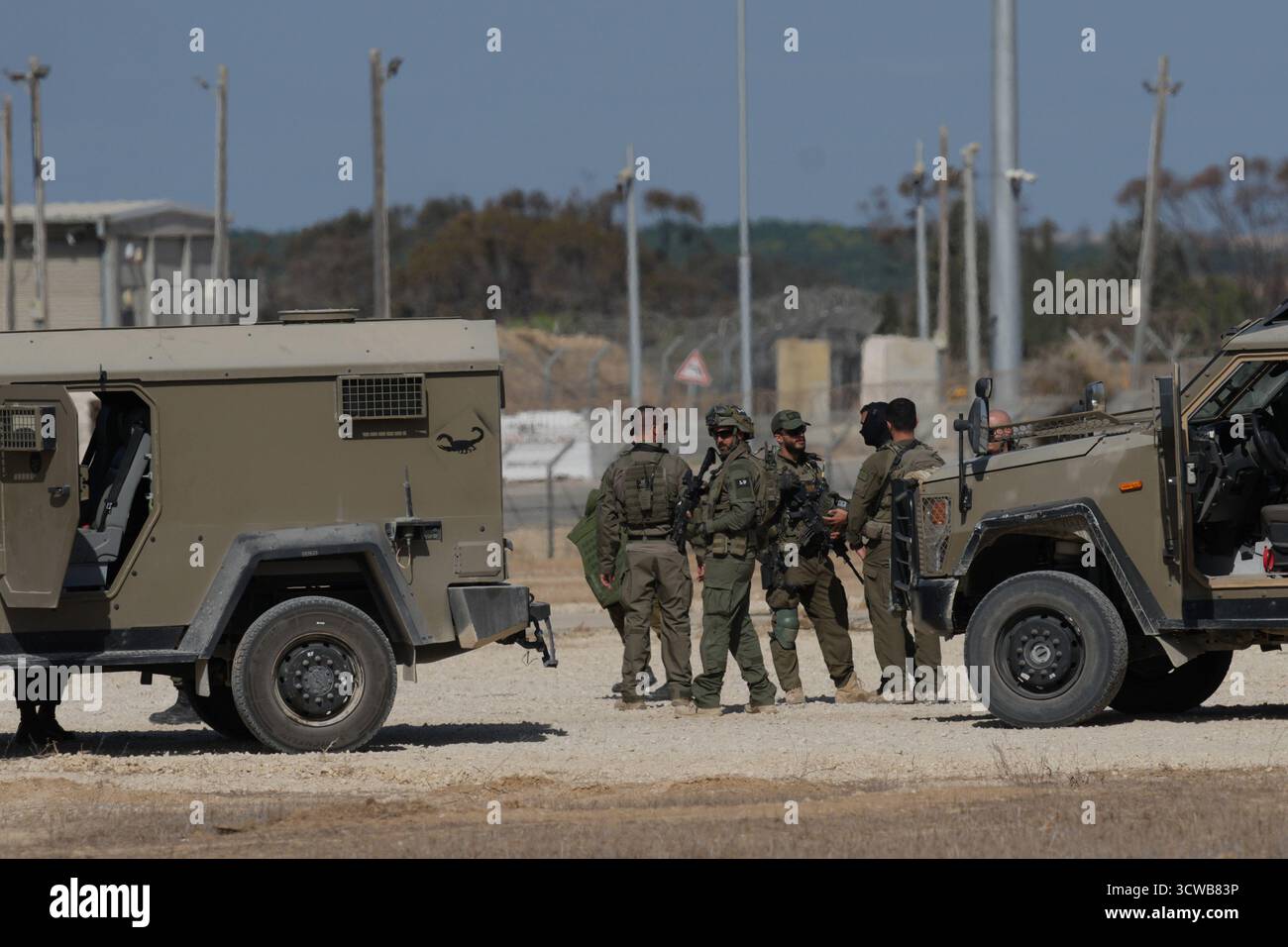 Members of the Israeli forces stand in an area of a military base ...
