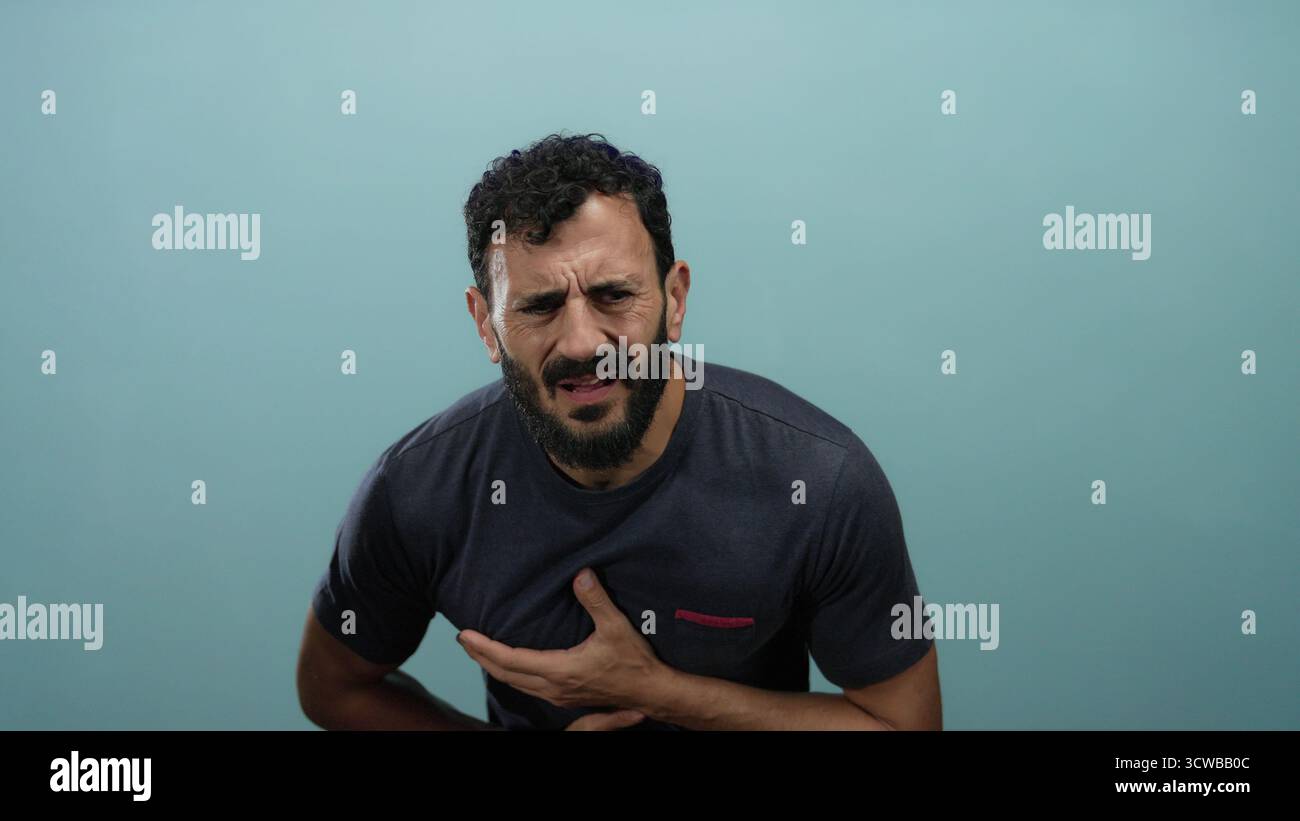 Hispanic man grasping chest hi-res stock photography and images - Alamy