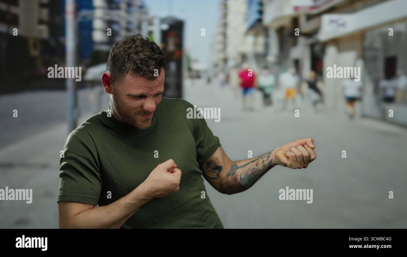 Young man tattoos mimics pulling hi-res stock photography and images ...