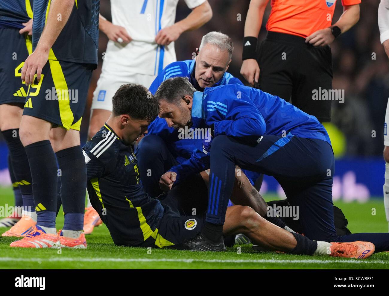 Scotland's Aaron Hickey comes off after an injury during the FIFA World ...