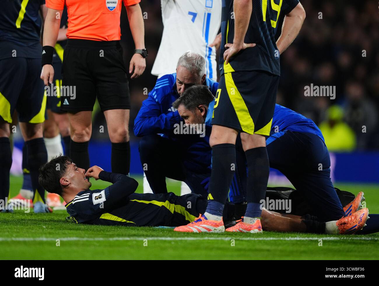 Scotland's Aaron Hickey comes off after an injury during the FIFA World ...