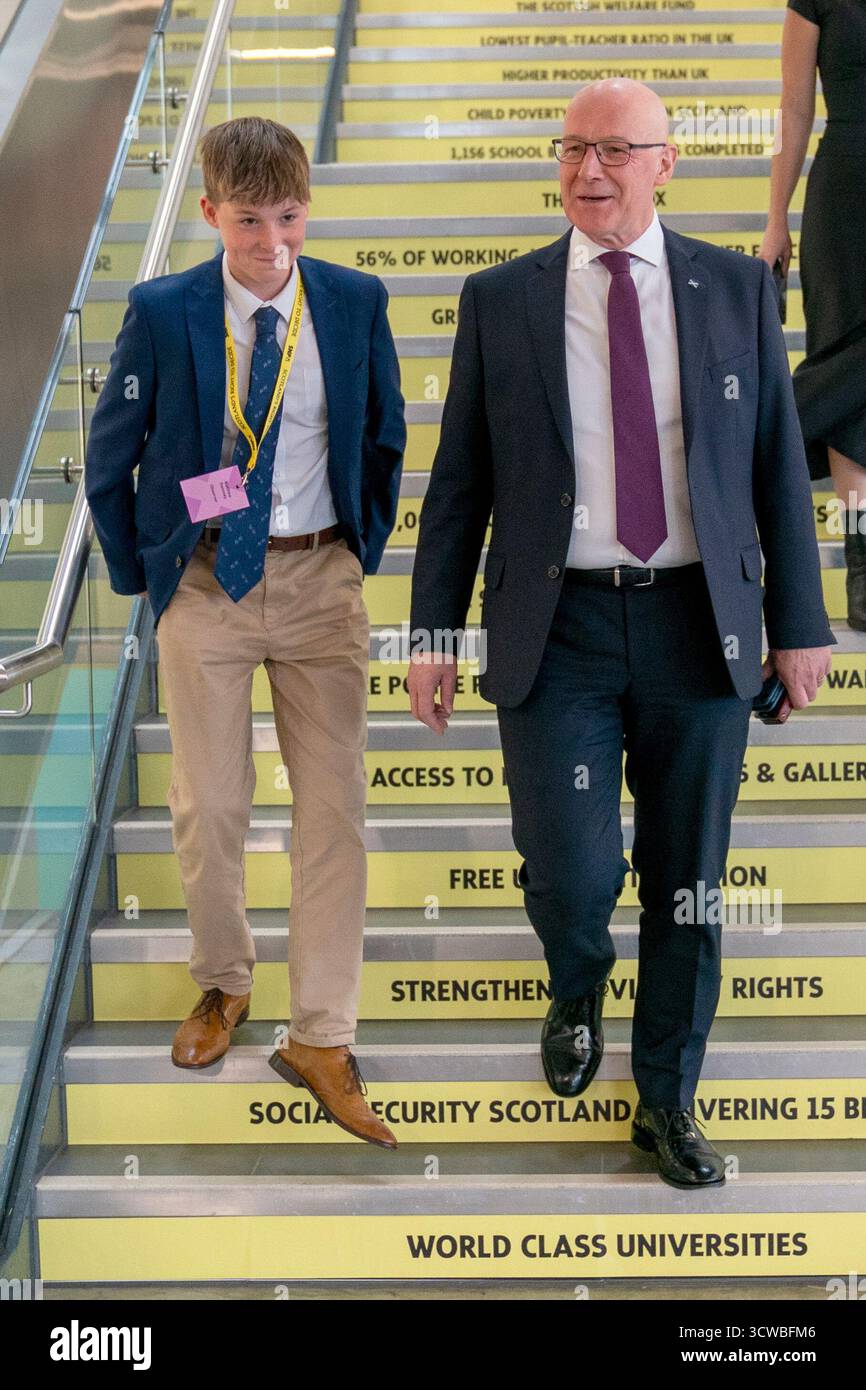 First Minister John Swinney arrives with his son Matthew (left) for the ...