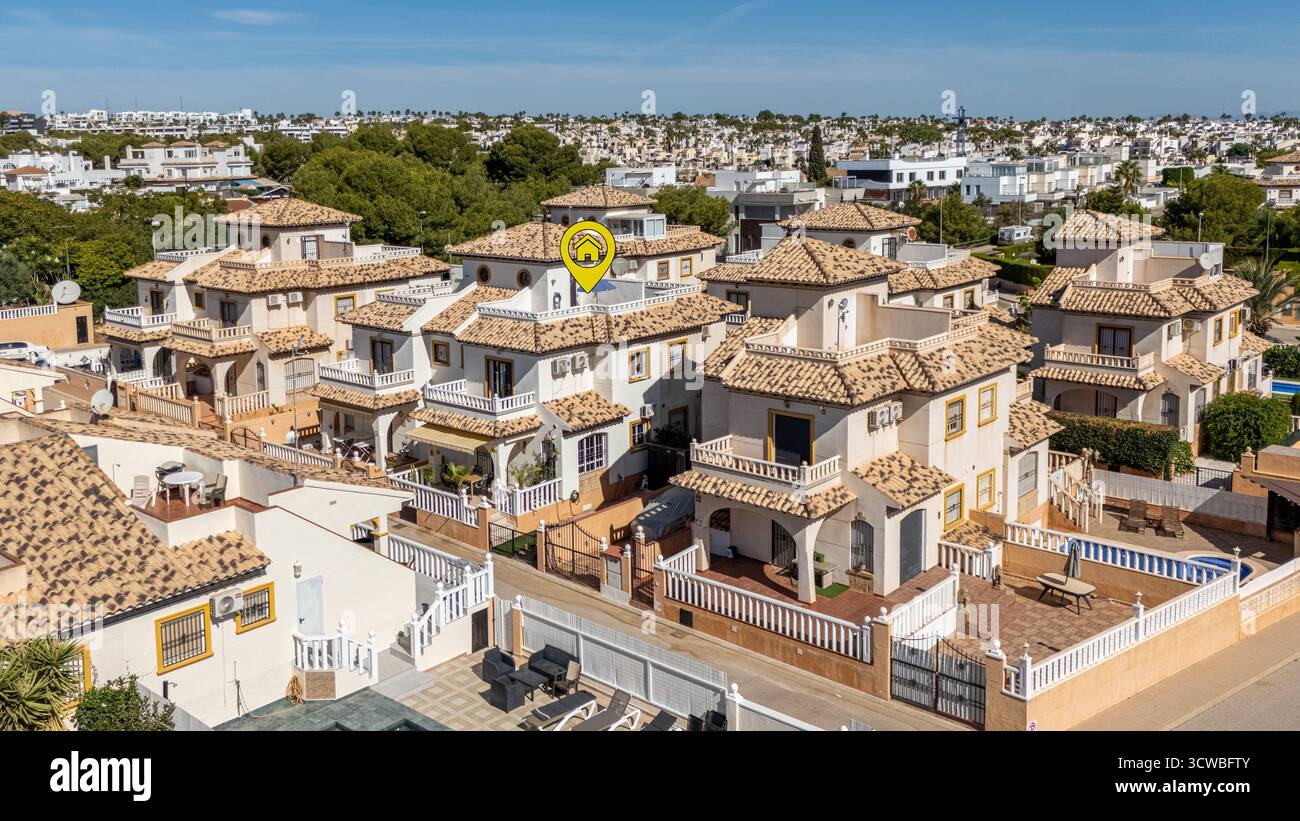 Drone view of a Mediterranean villa with tiled roof and white railings ...
