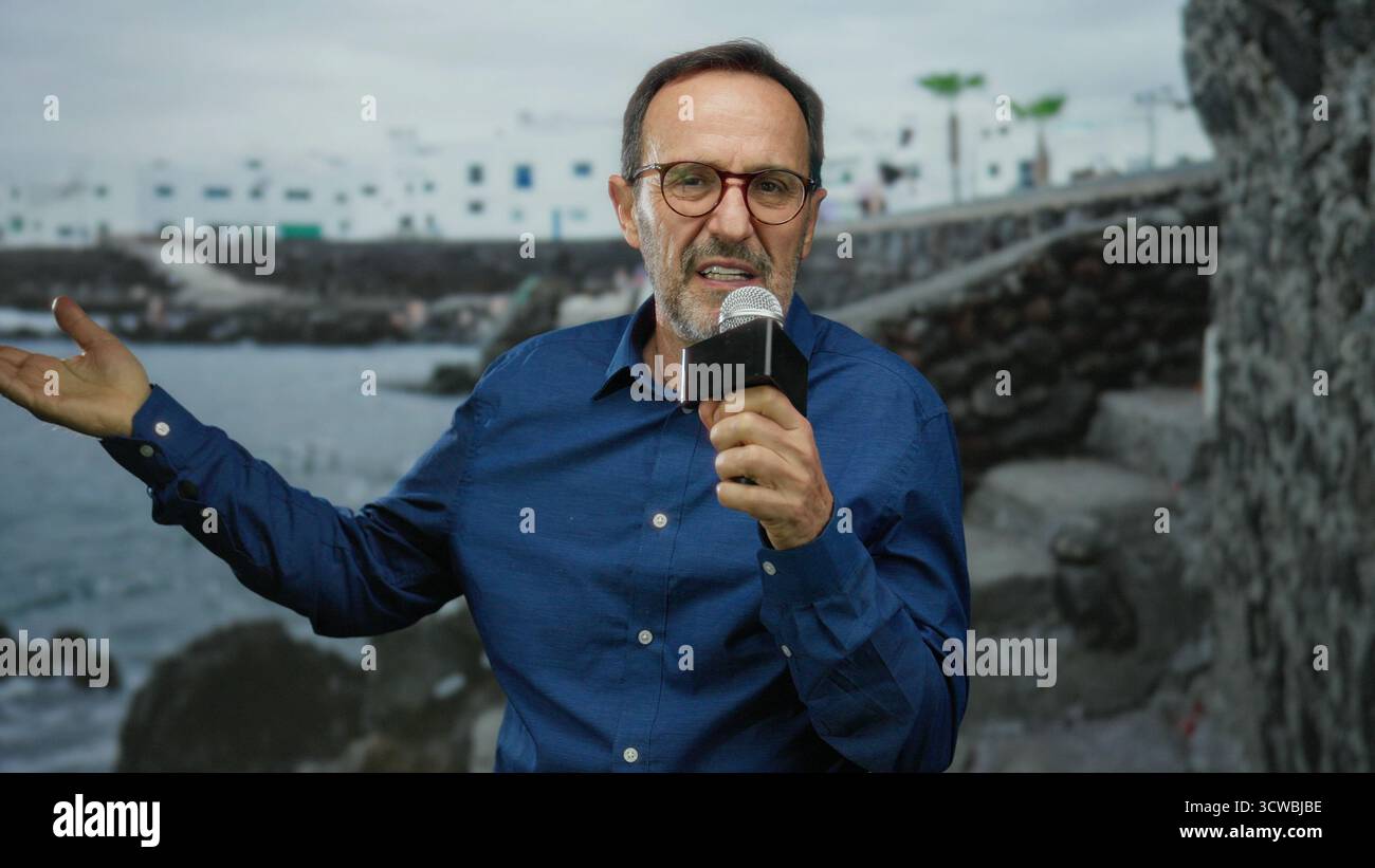 Man speaking microphone seaside wearing hi-res stock photography and ...