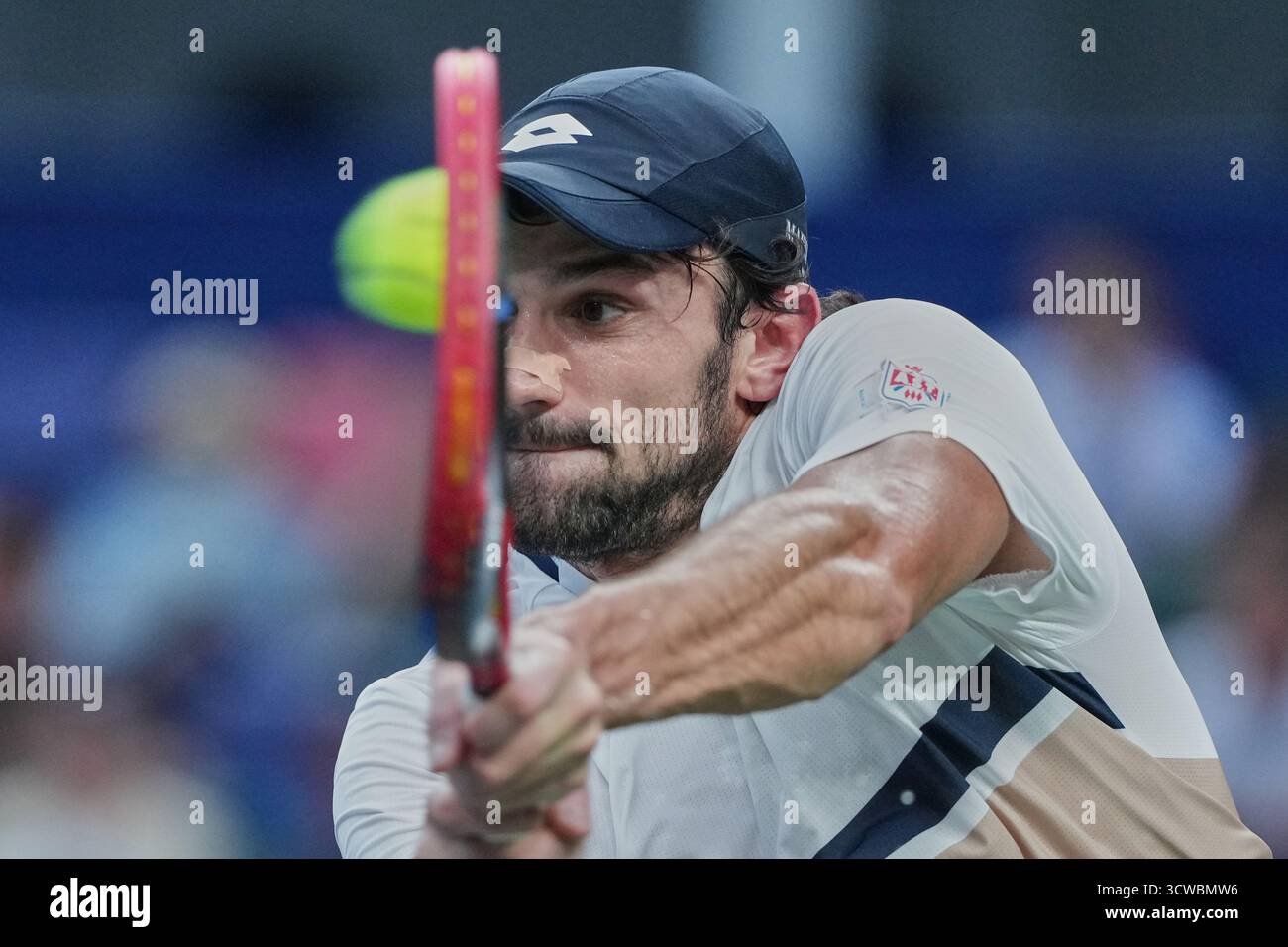 Valentin Vacherot of Monaco plays a backhand return to Novak Djokovic ...