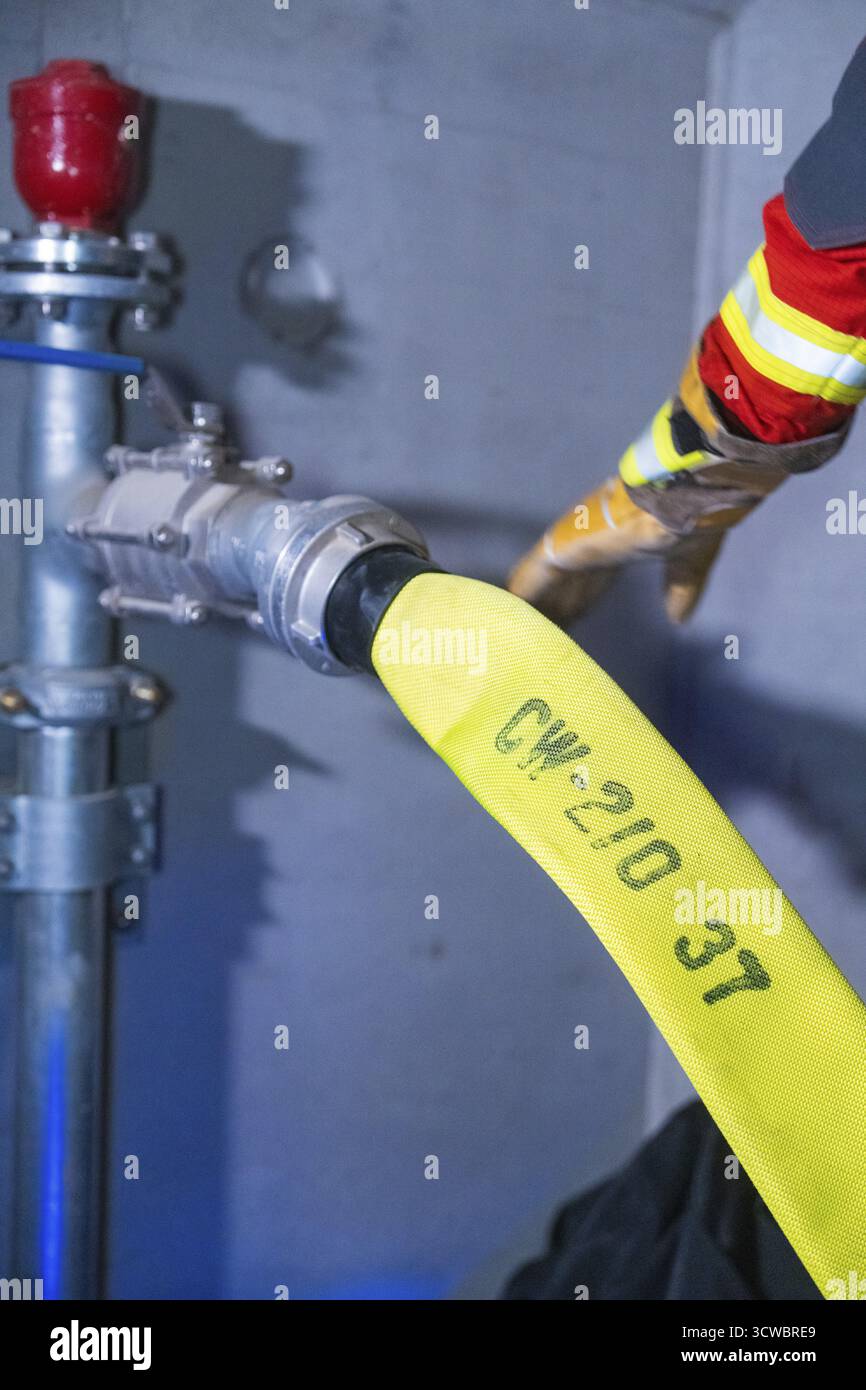 Fire hose being connected to hydrant, close-up of the connection, fire ...