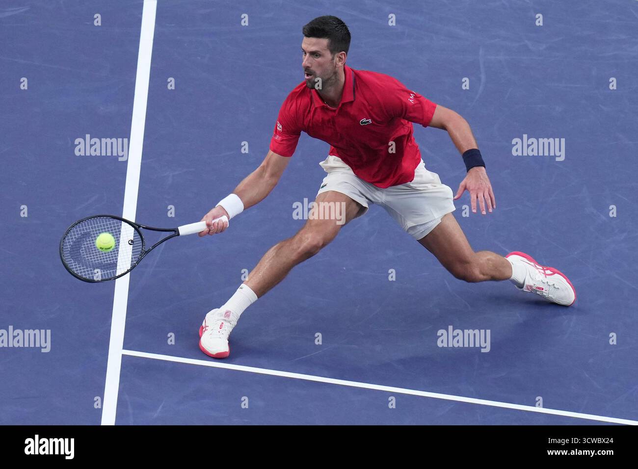 Novak Djokovic of Serbia returns a forehand shot from Valentin Vacherot ...