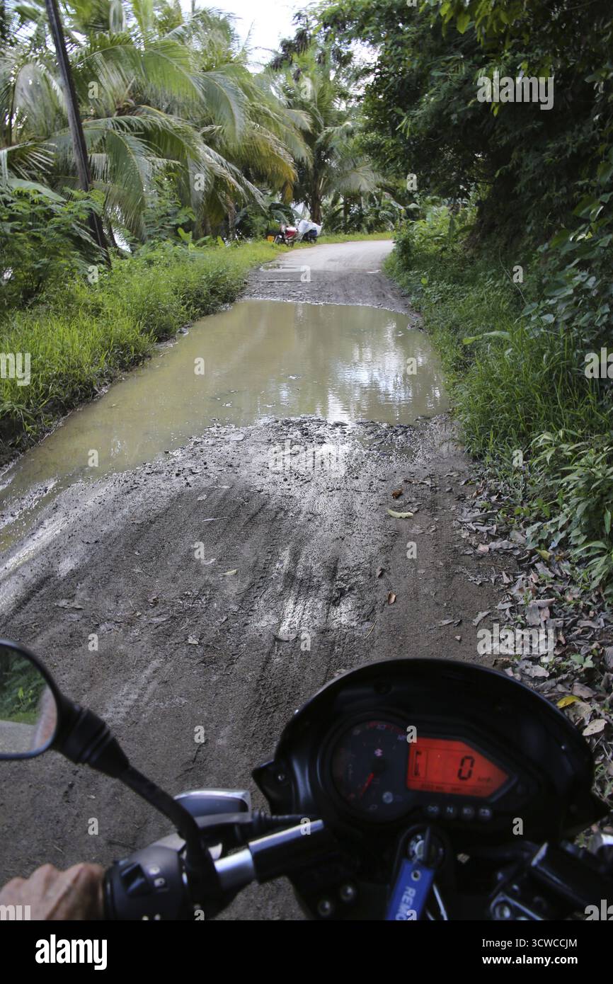 Puddles on an unpaved road, San Ricardo, Panaon Island, Southern Leyte ...