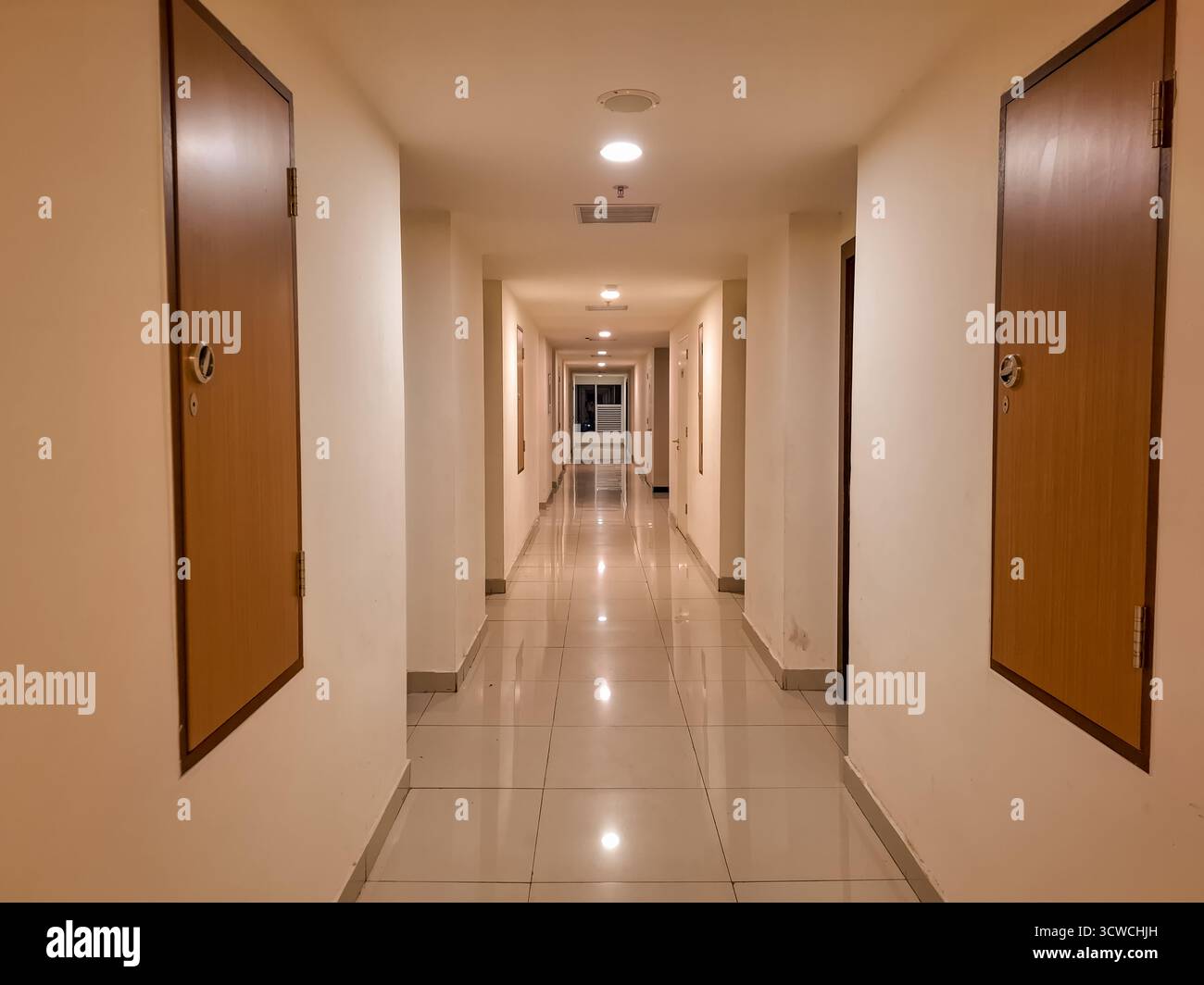 Long Indoor Hallway With Two Wooden Doors On Each Side Reflective Floor ...