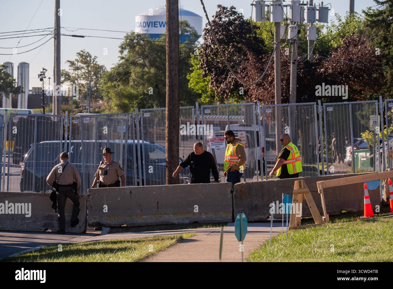 Workers, alongside Illinois State Police, install new concrete barriers ...