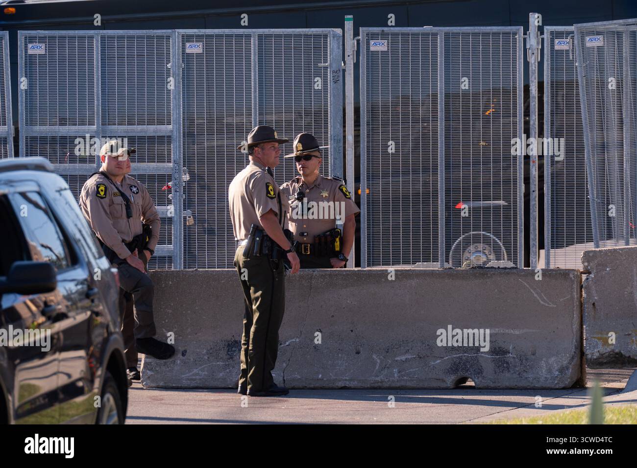 Illinois State Police look at newly installed concrete barriers outside ...