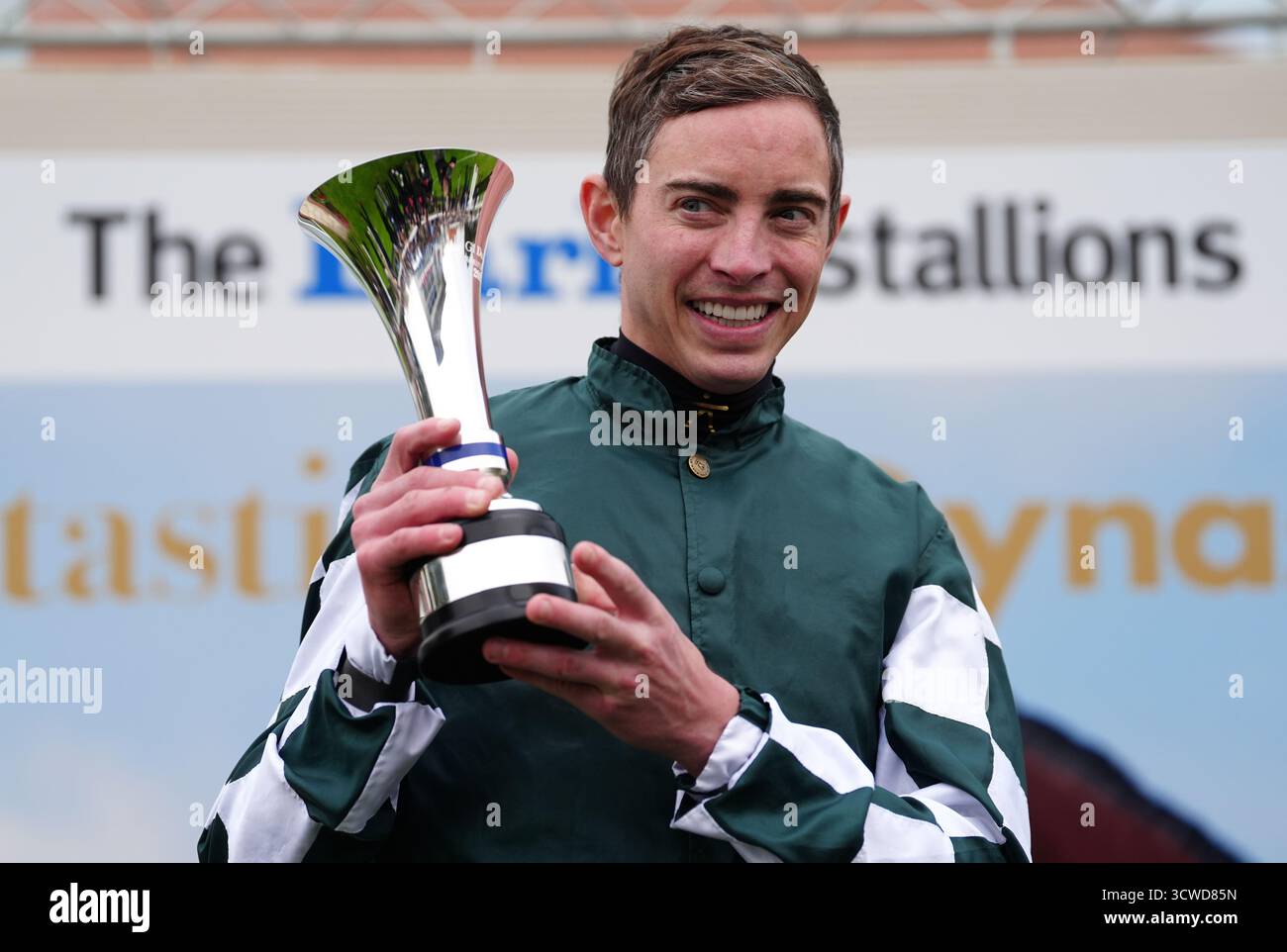 James Doyle celebrates with the trophy after winning the Darley ...
