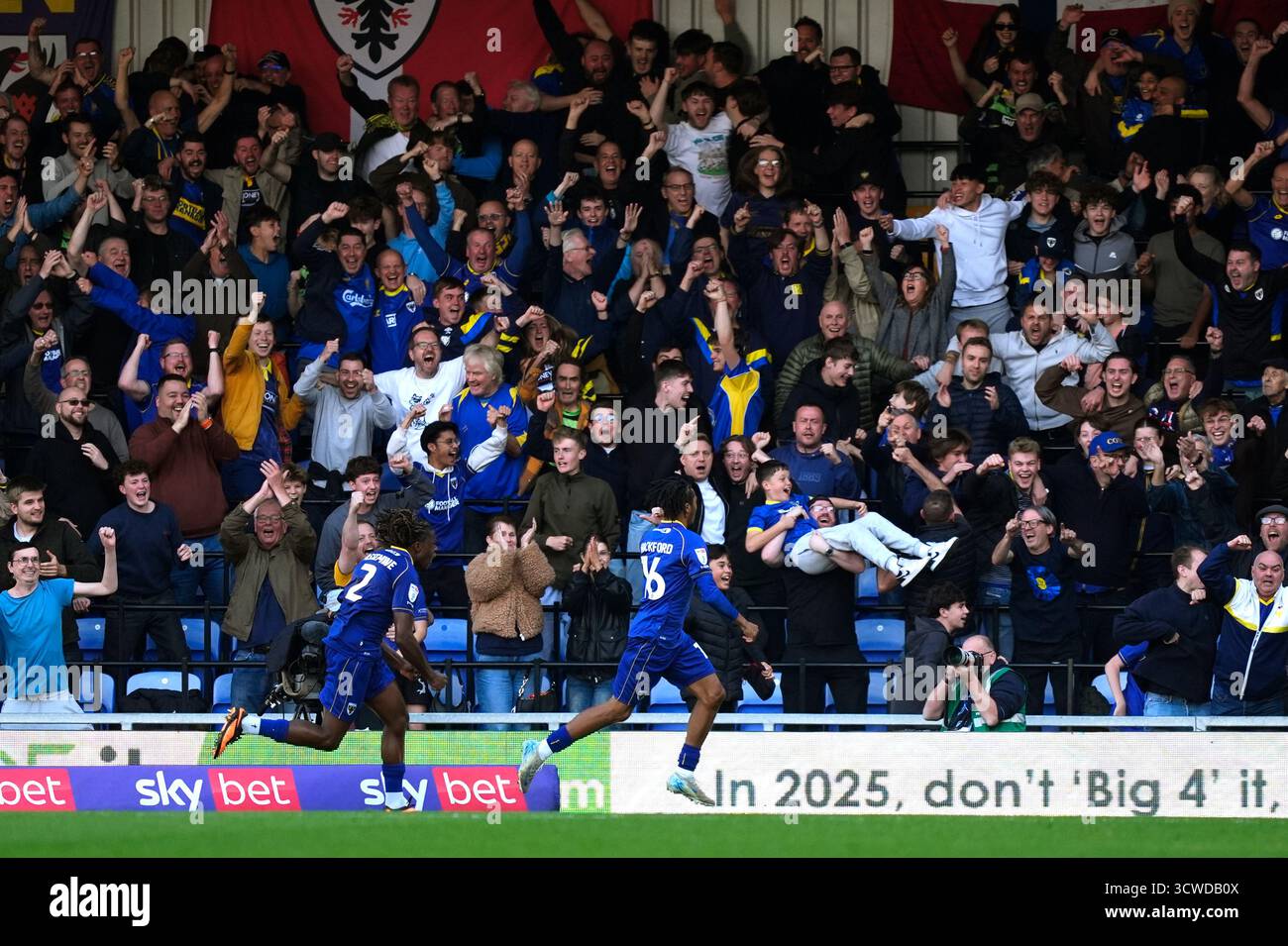 AFC Wimbledon's Antwoine Hackford (centre) celebrates scoring their ...