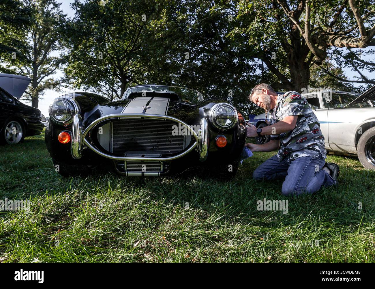 Carey Bertke polishes the wheels on his 1966 Shelby Cobra replica ...