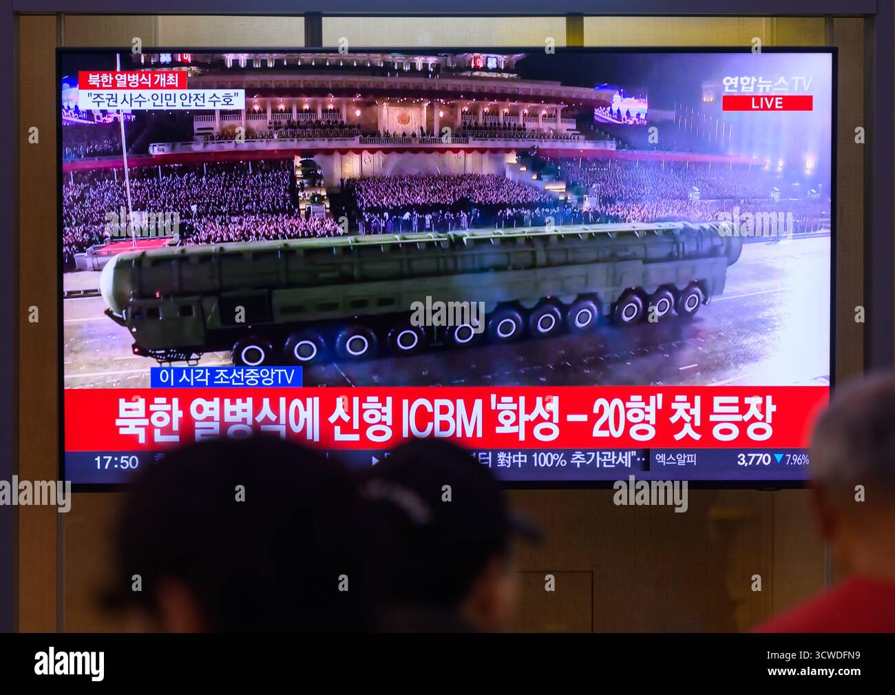 People look at a 24-hour Yonhap news TV broadcast at Seoul Railway ...