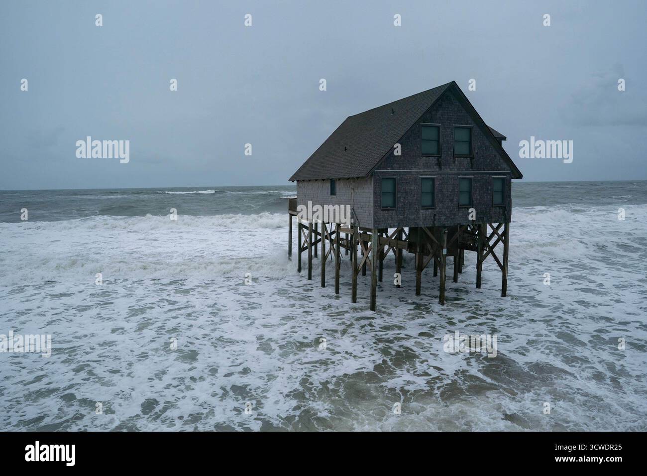 A home at risk of collapse is seen as a storm approaches, Saturday, Oct ...