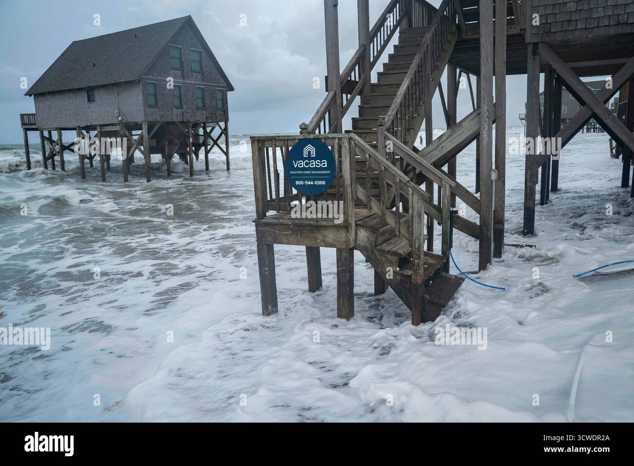 A vacation rental sign is seen on a home at risk of collapse as a storm ...