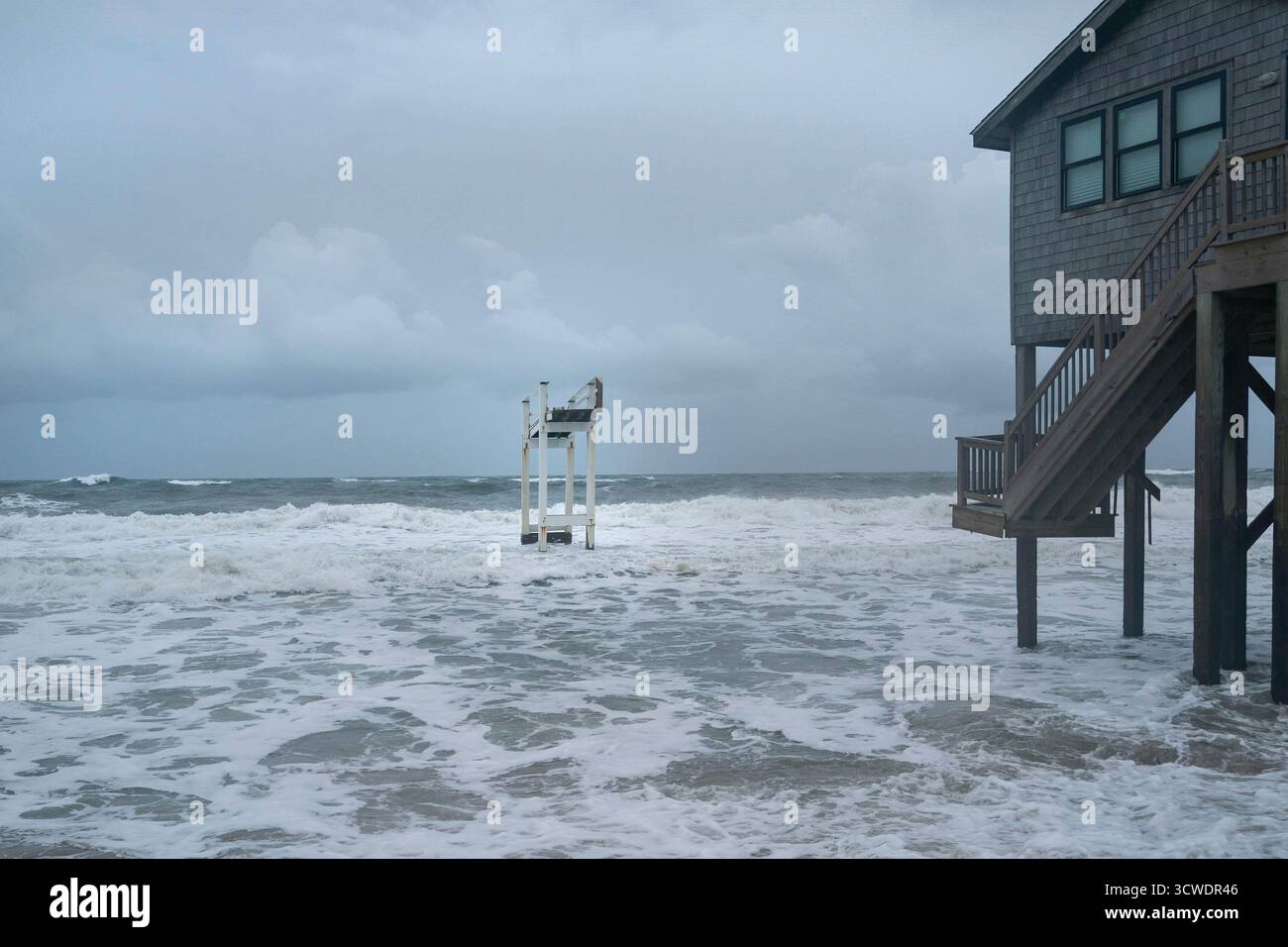The remnants of a home are seen as a storm approaches, Saturday, Oct ...