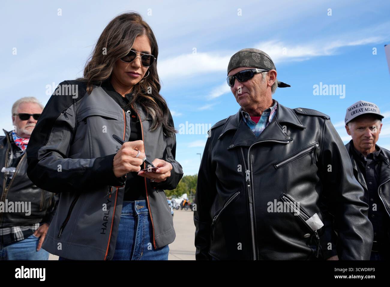 U.S. Secretary of Homeland Security Kristi Noem signs an autograph ...