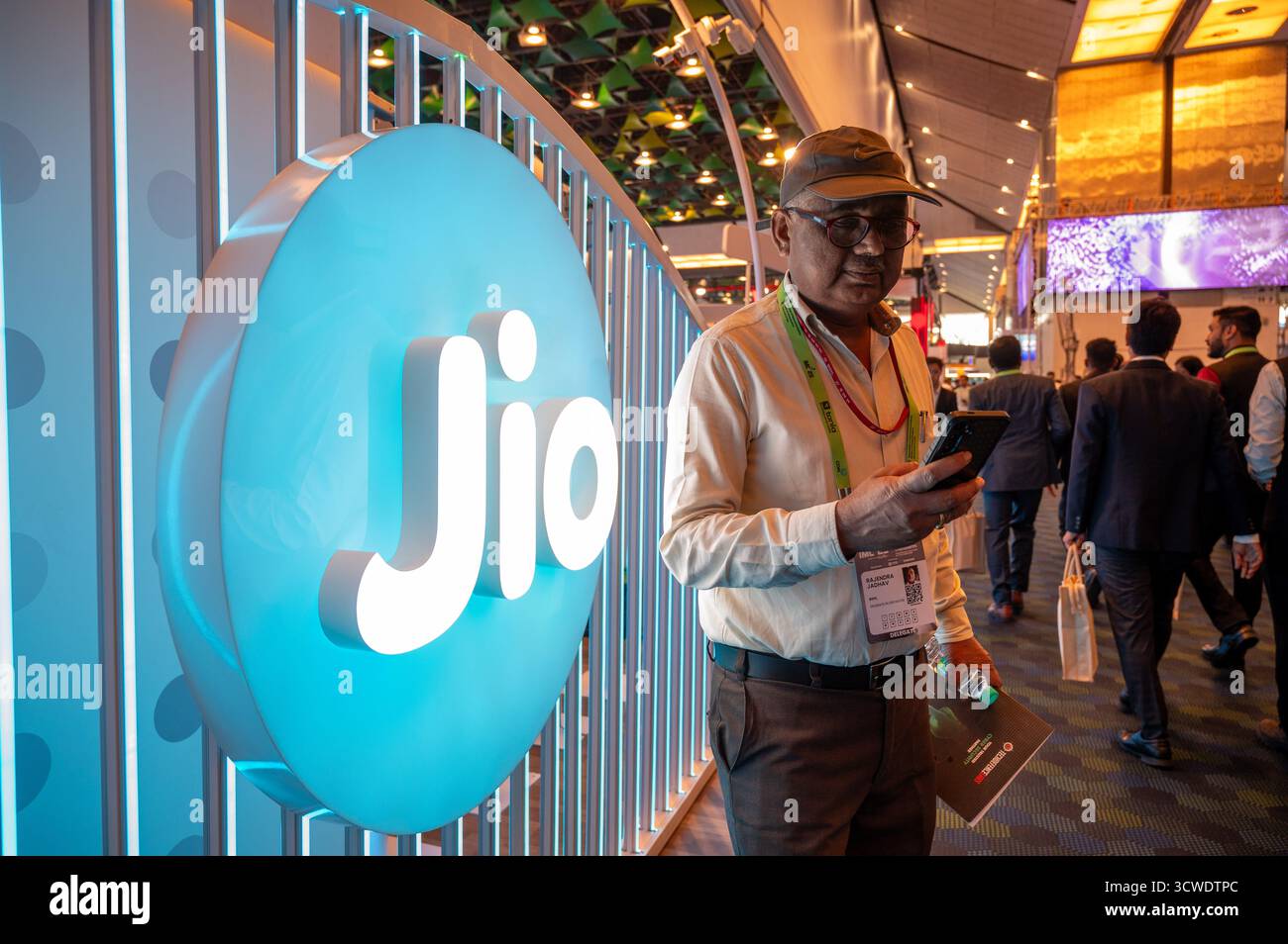 A visitor browses his phone at the Jio ( Jio is India's largest digital ...