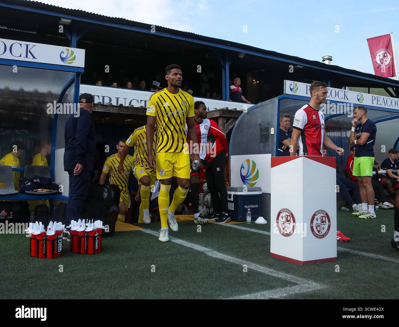 WOKING, ENGLAND - OCTOBER 11: The players walk out before the FA Cup ...