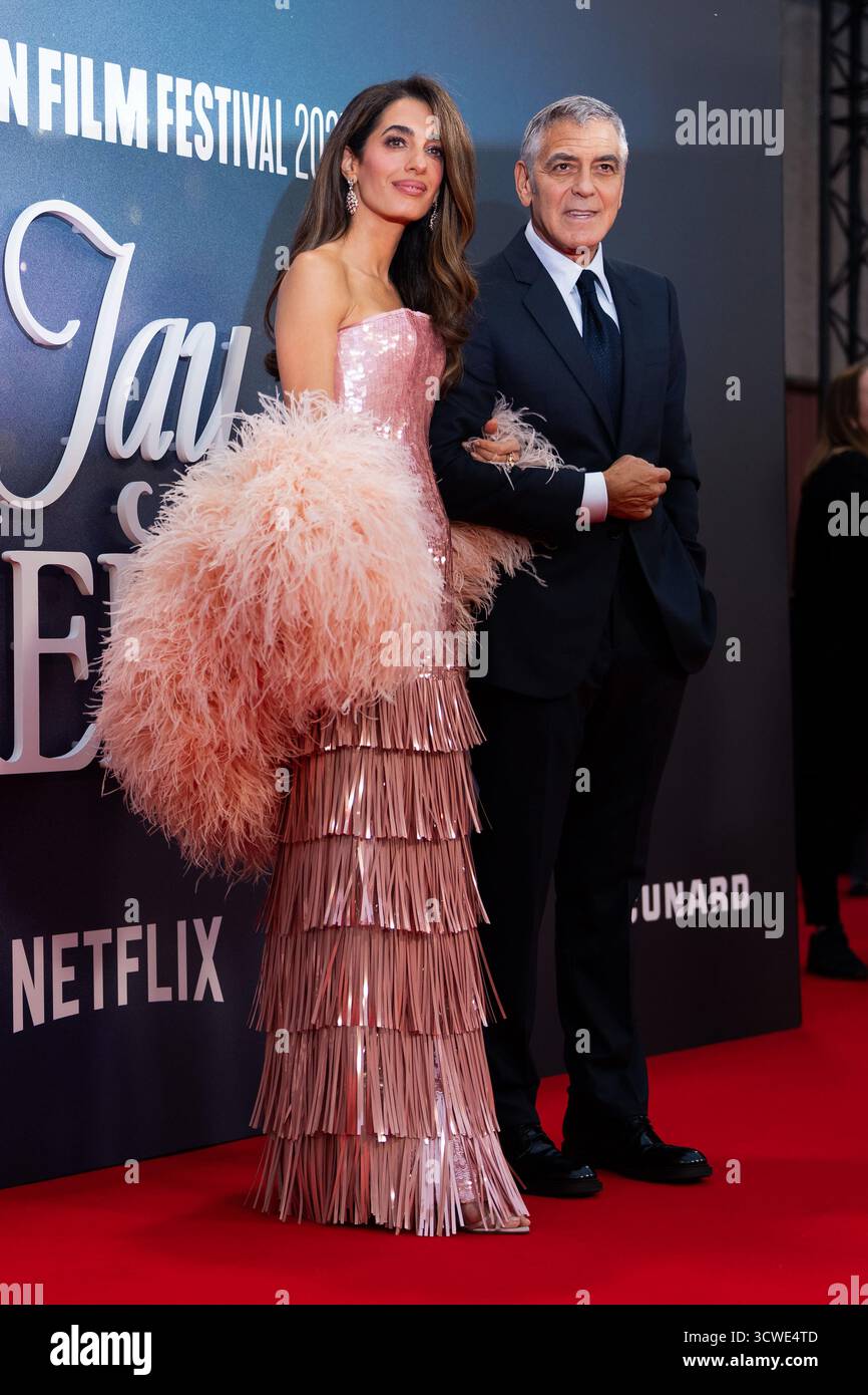 Amal Clooney, left, and George Clooney pose for photographers upon ...