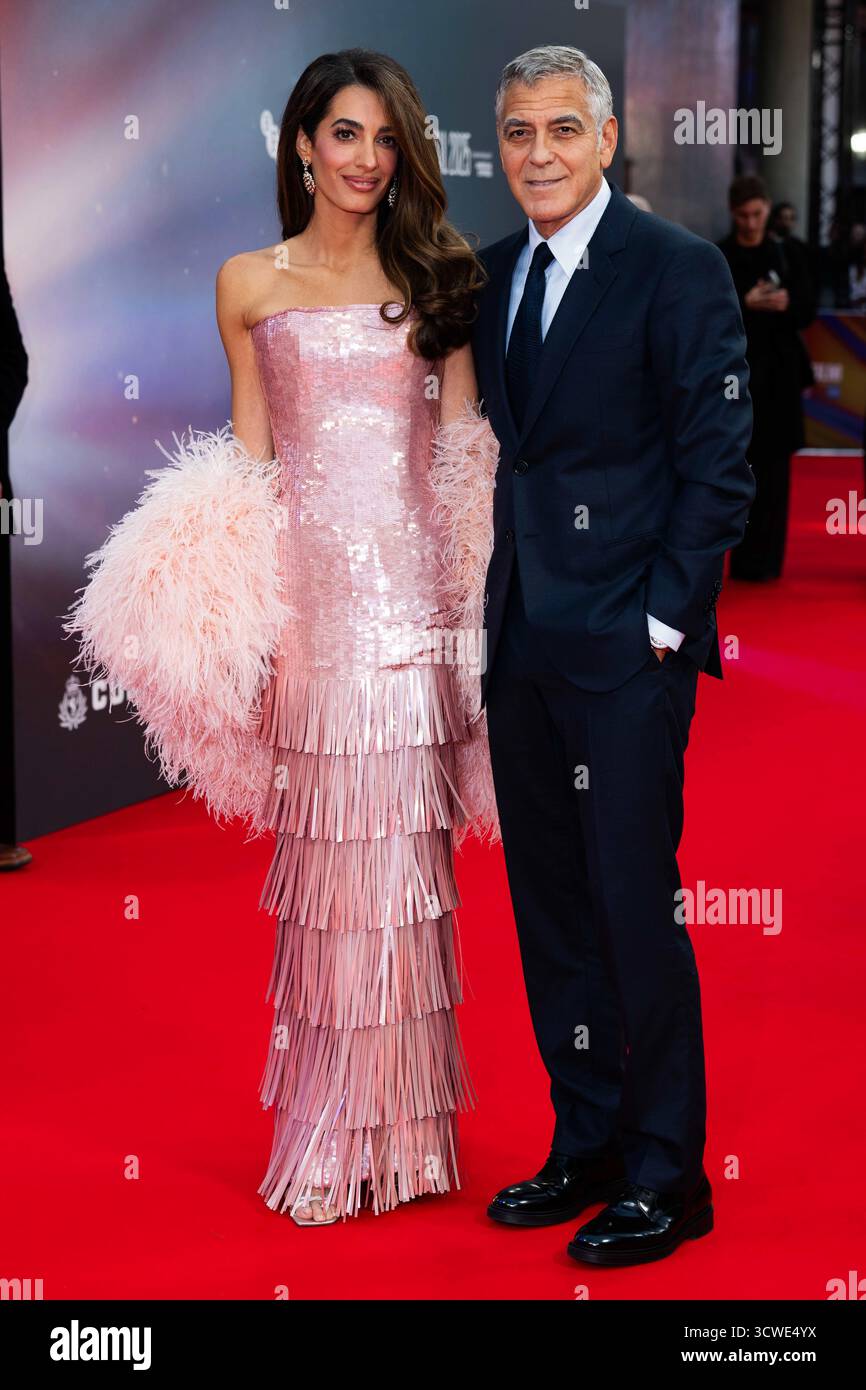 Amal Clooney, left, and George Clooney pose for photographers upon ...