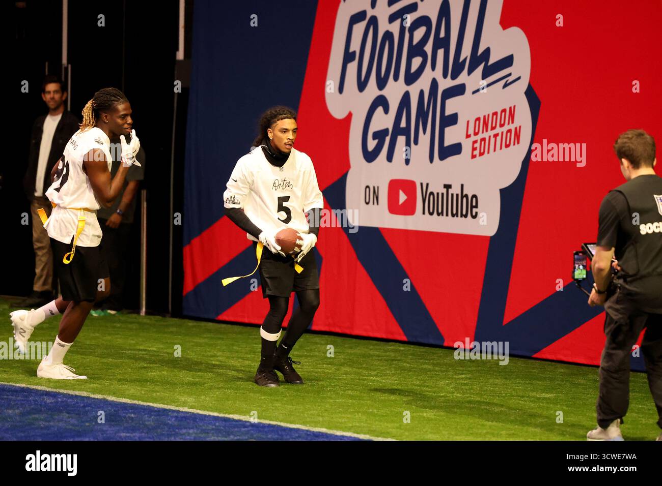 Team Aitch's Jay Cinco (5) celebrates after a touchdown against Team ...