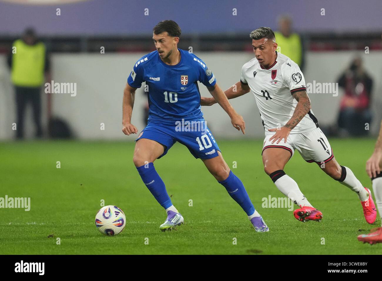 Serbia's Sasa Lukic, left, is challenged by Albania's Myrto Uzuni ...