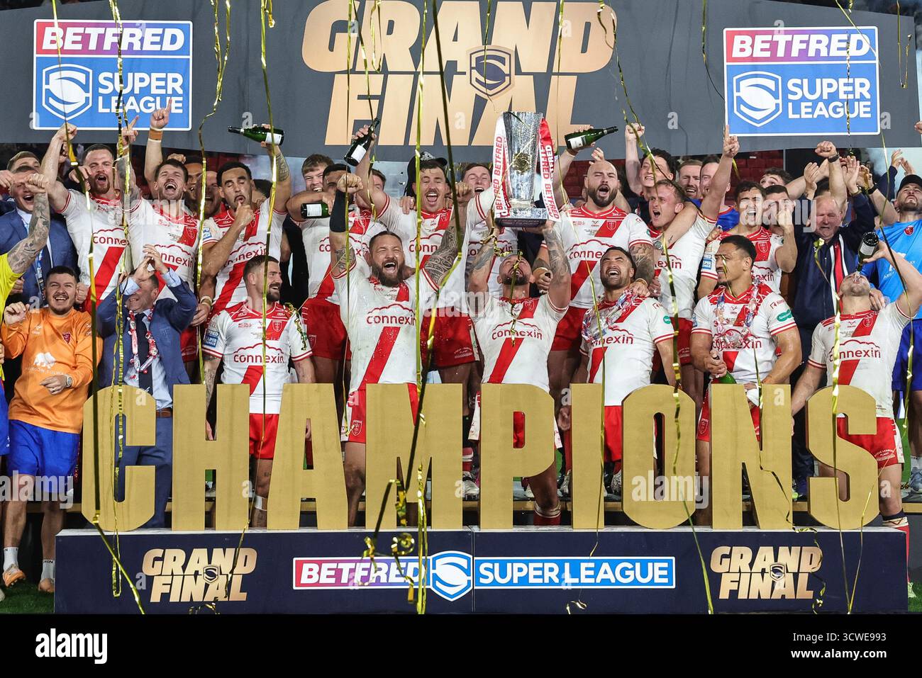 Elliot Minchella of Hull KR and his team mates and staff lift the Grand ...