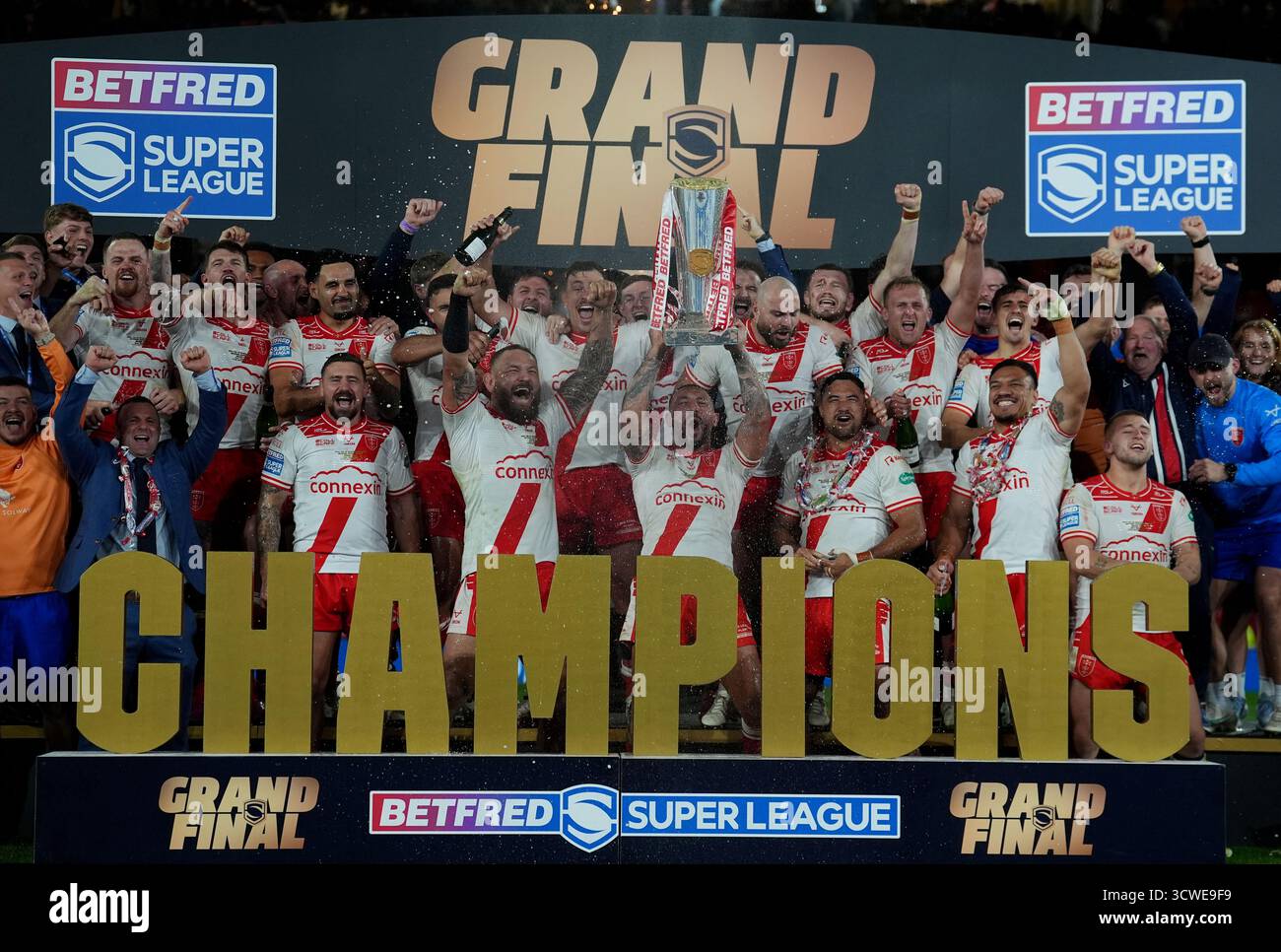 Hull KR's Elliot Minchella (centre) lifts the trophy as his team ...