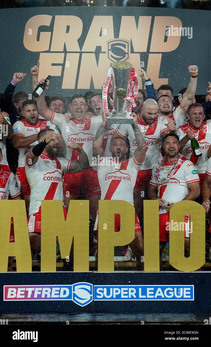 Hull KR's Elliot Minchella (centre) lifts the trophy as his team ...