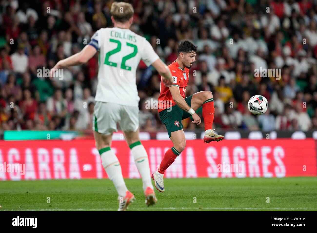 Pedro Neto of Portugal, back, controls a ball next to Nathan Collins of ...