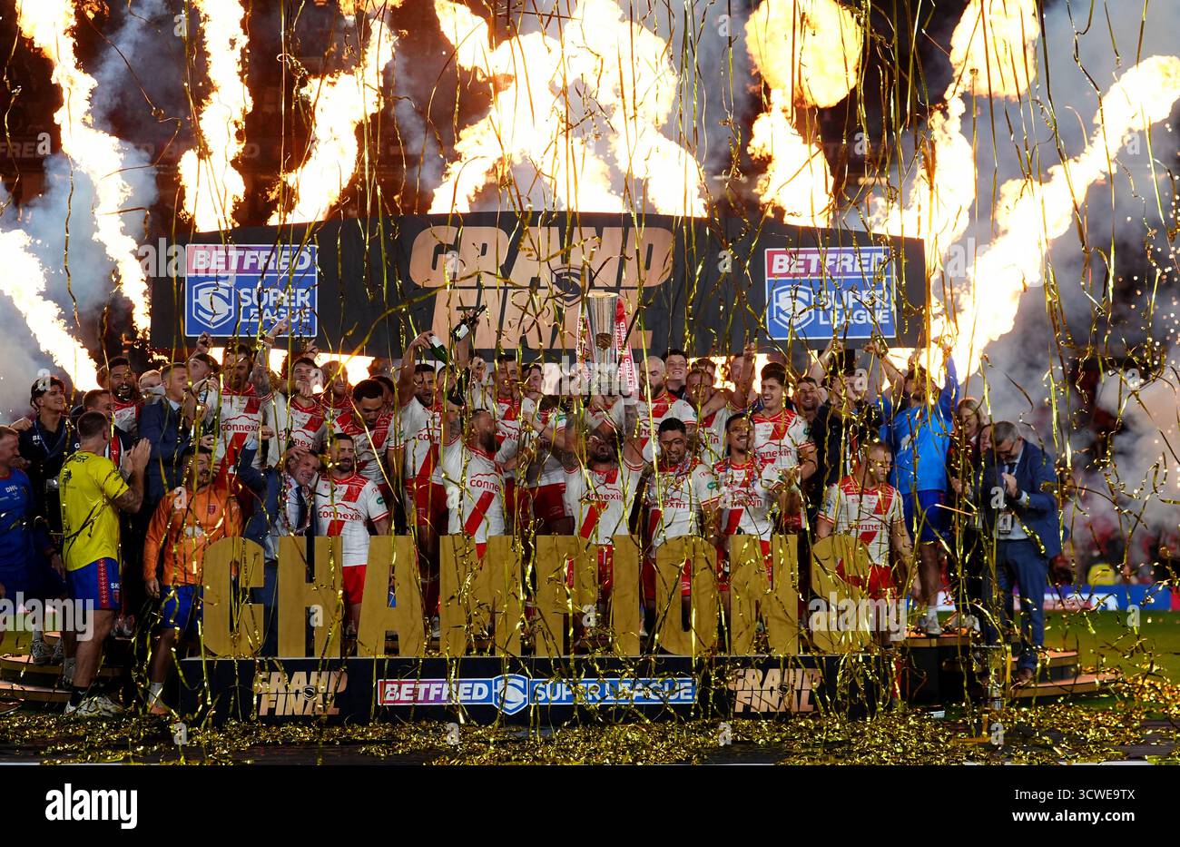 Hull KR's Elliot Minchella (centre) lifts the trophy as his team ...