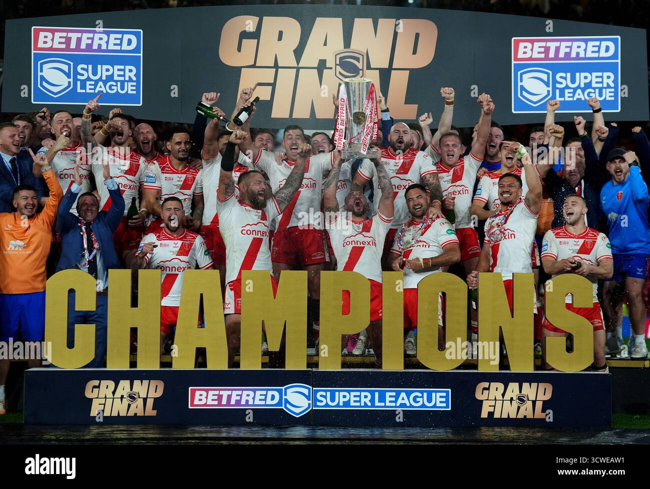 Hull KR's Elliot Minchella (centre) lifts the trophy as his team ...