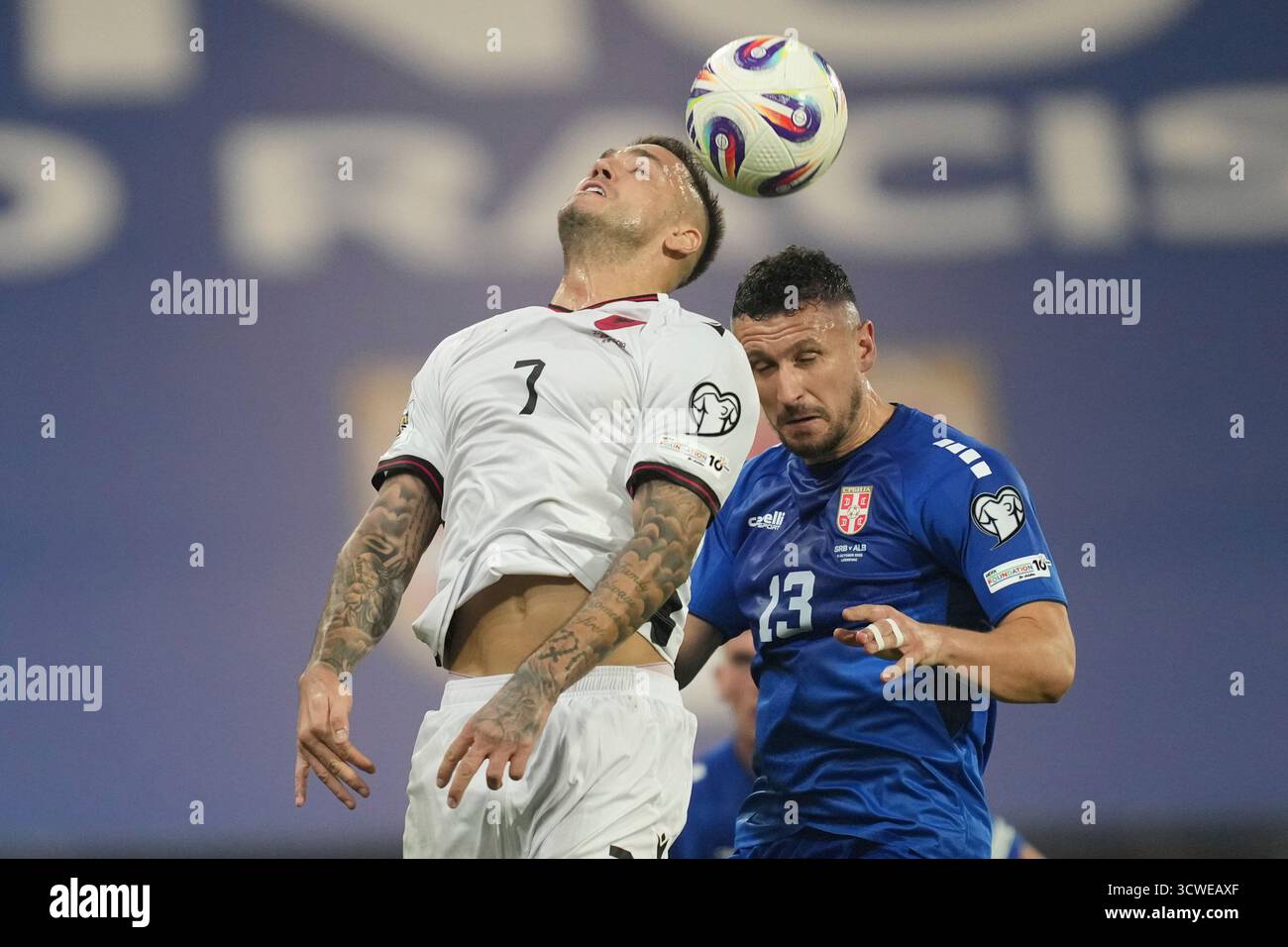 Albania's Rey Manaj, left, jumps for a header with Serbia's Milos ...