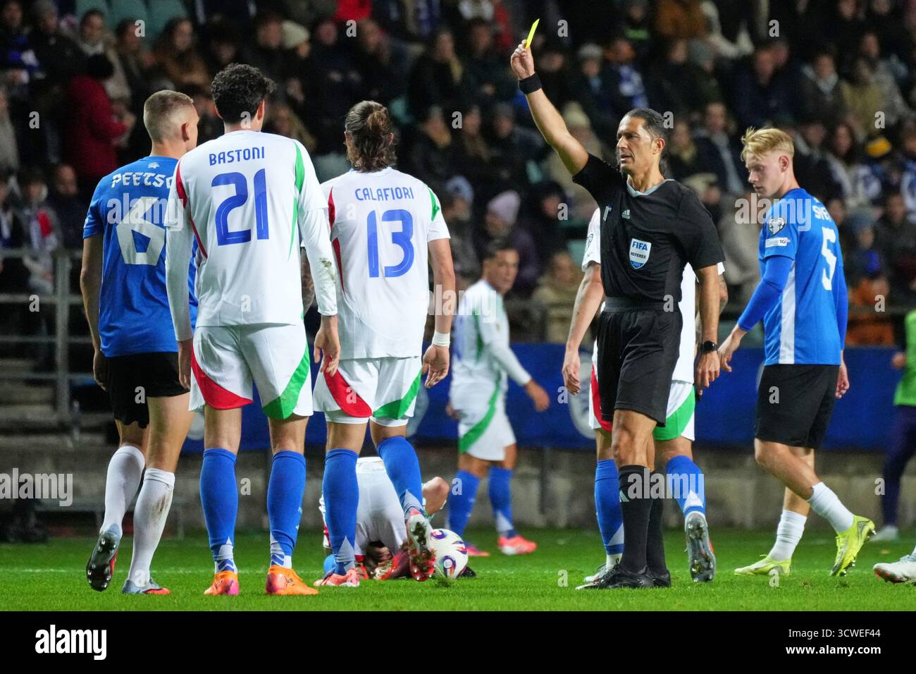 Referee Serdar Gozubuyuk gives a yellow card to Estonia's Rasmus ...