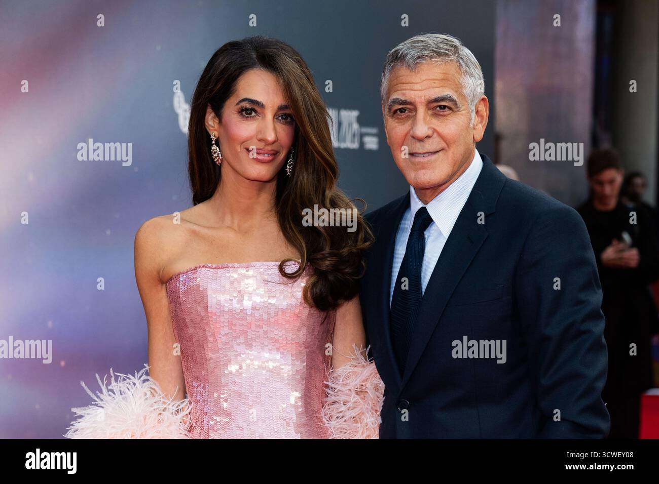 Amal Clooney, left, and George Clooney pose for photographers upon ...